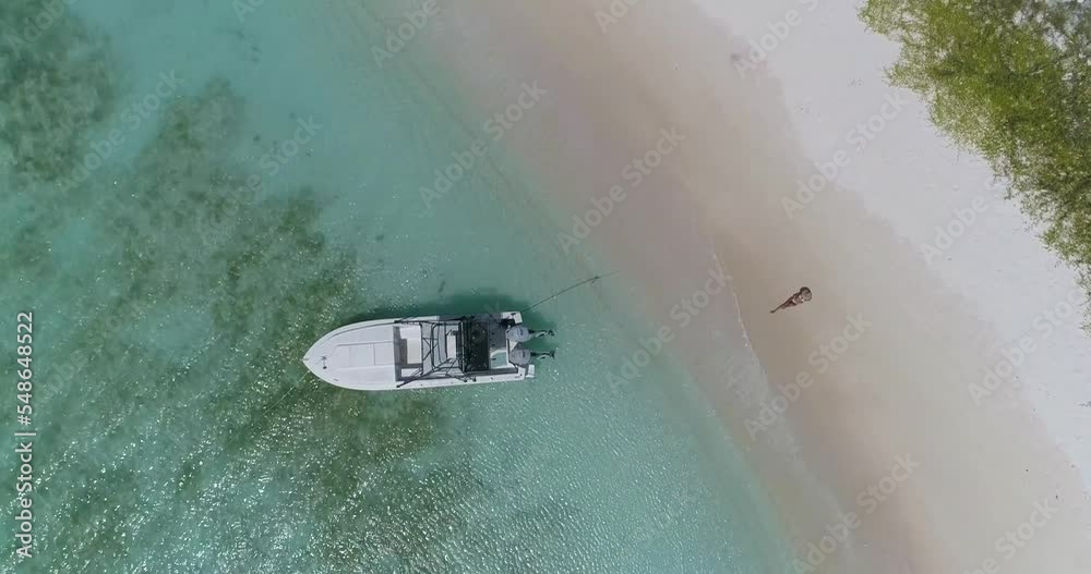 Vidéo Stock WOMAN LYING ON SAND BEACH, DRONE SHOT TURN OVER YACHT, LOS ...