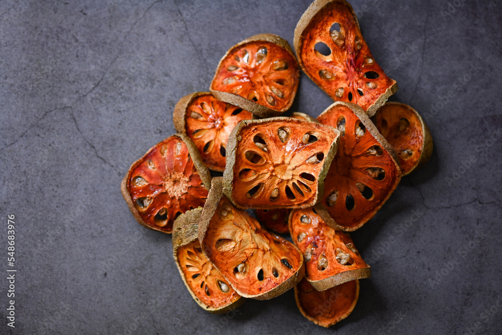 Dried bael slices on dark background, Bael for bael juice - Dry bael ...