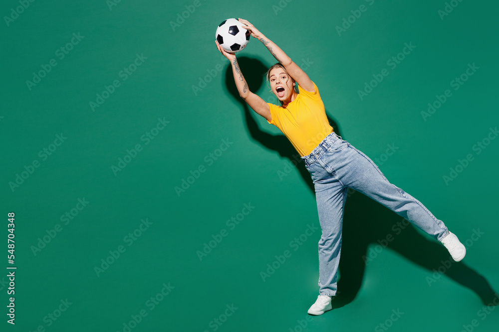 Full body young goalkeeper cheerful woman fan wearing basic yellow t ...