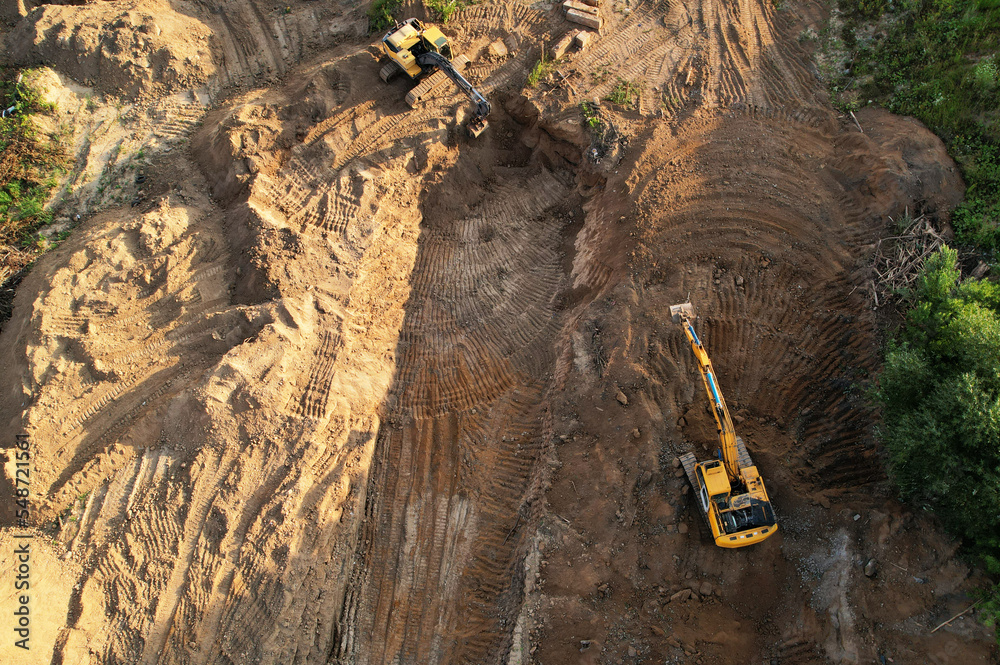 Excavator on earthmoving at construction site, aerial view. Excavator ...