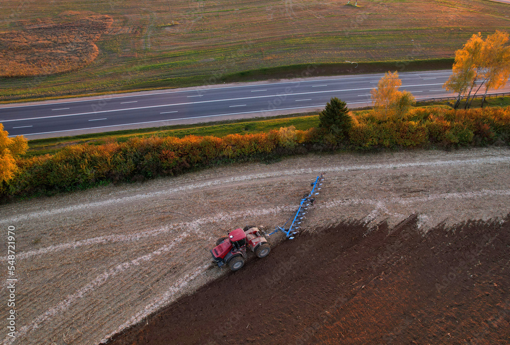 Tractor Plowing field, top view. Red Tractor with Plough on Plowed ...