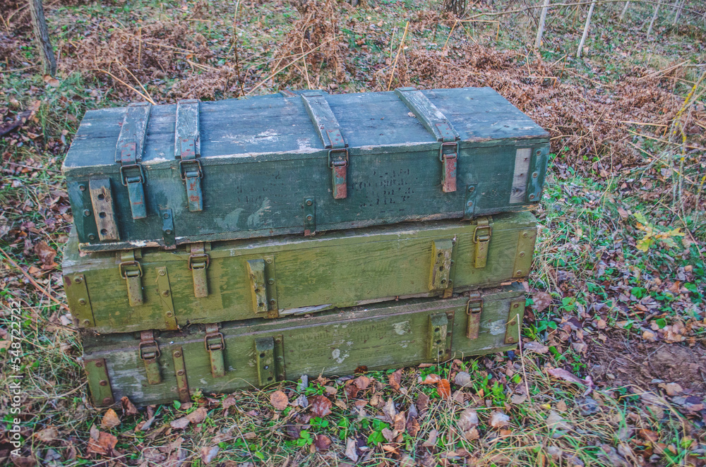 Weapon box. Box with weapons and ammunition in the forest. Old wooden ...