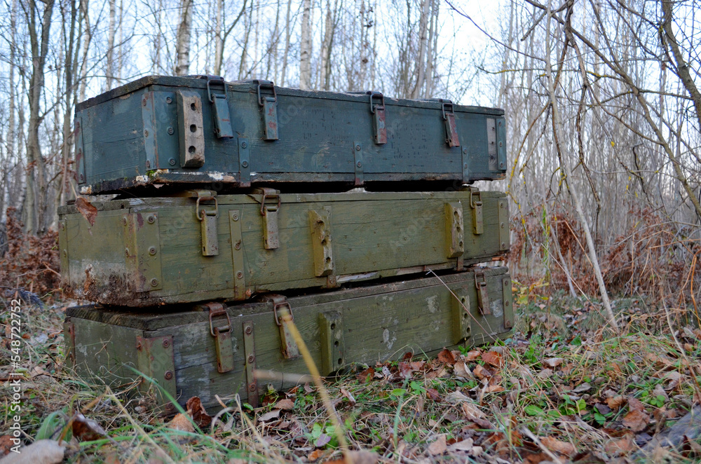 Weapon box. Box with weapons and ammunition in the forest. Old wooden ...