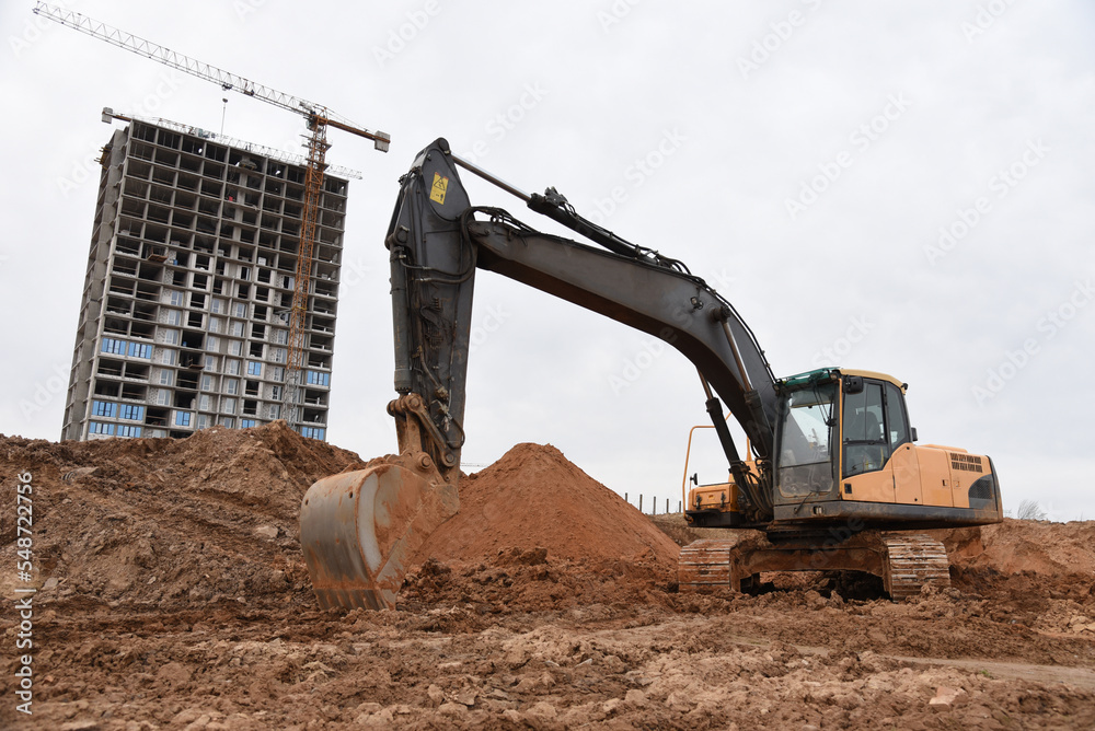 Excavator dig ground at construction site. Dig foundation. Construction ...