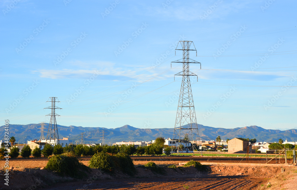 High voltage electricity pylons and transmission power lines in farm ...