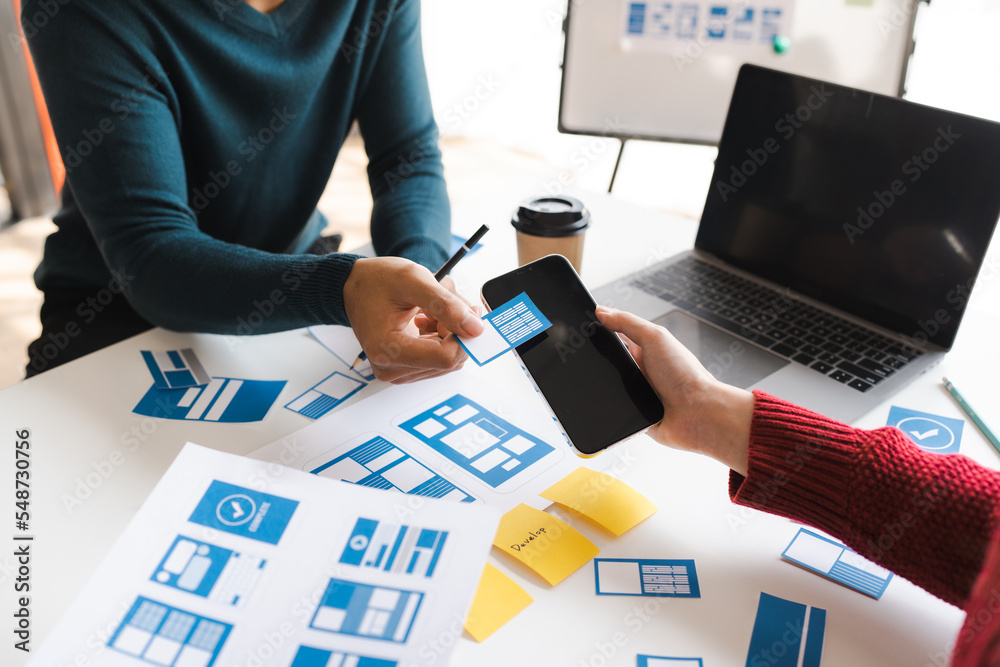 Working at desk, start up, UX team works from a single location under a ...