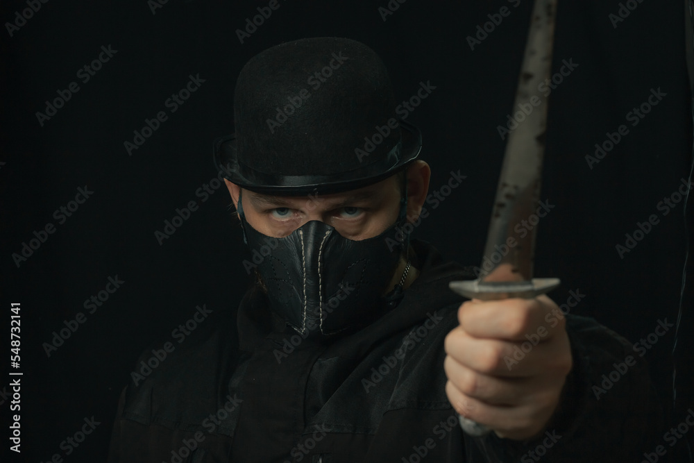 Scary man with knife or dagger creepy mask and hat in the dark Stock ...