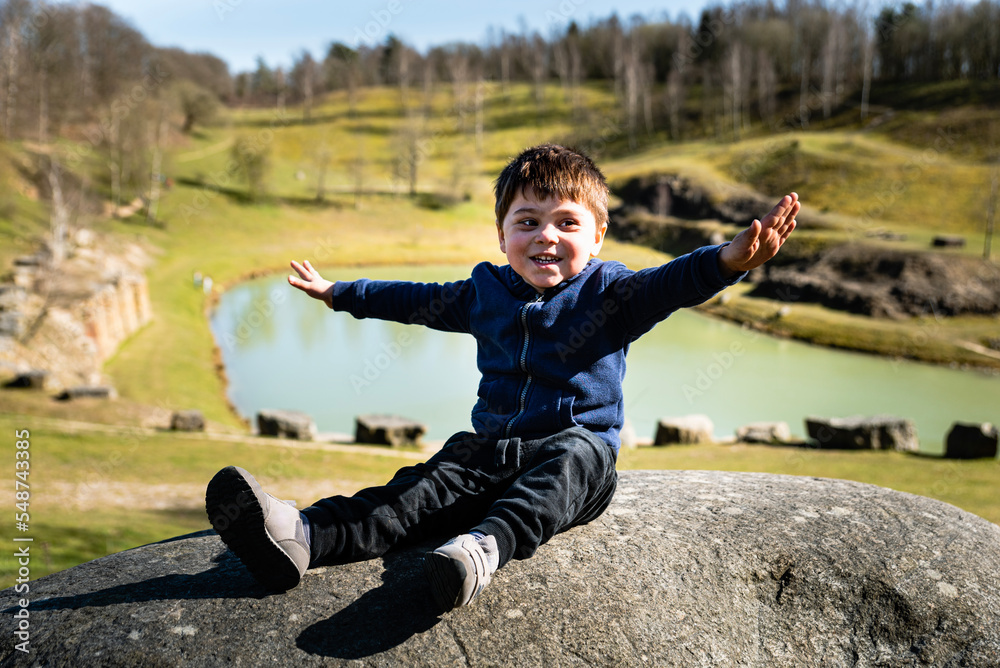 Happy kid with open arms pretending to be a plane pilot sitting on ...