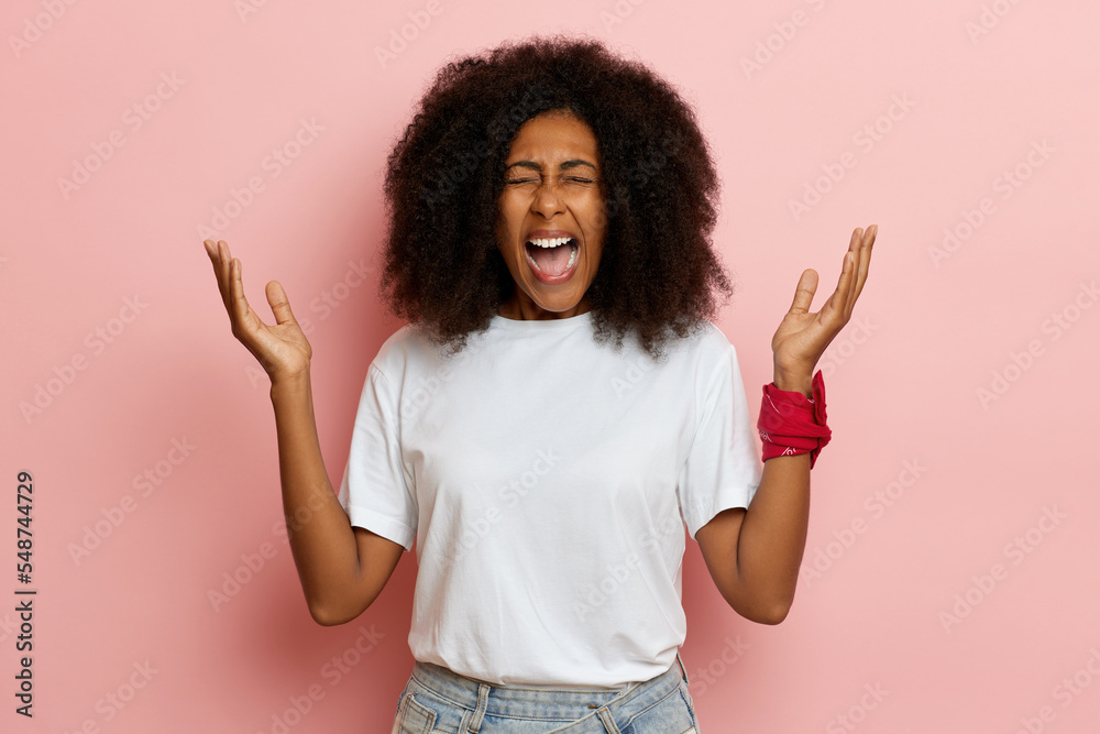 portrait of a screaming girl, she raised her hands to her face and ...