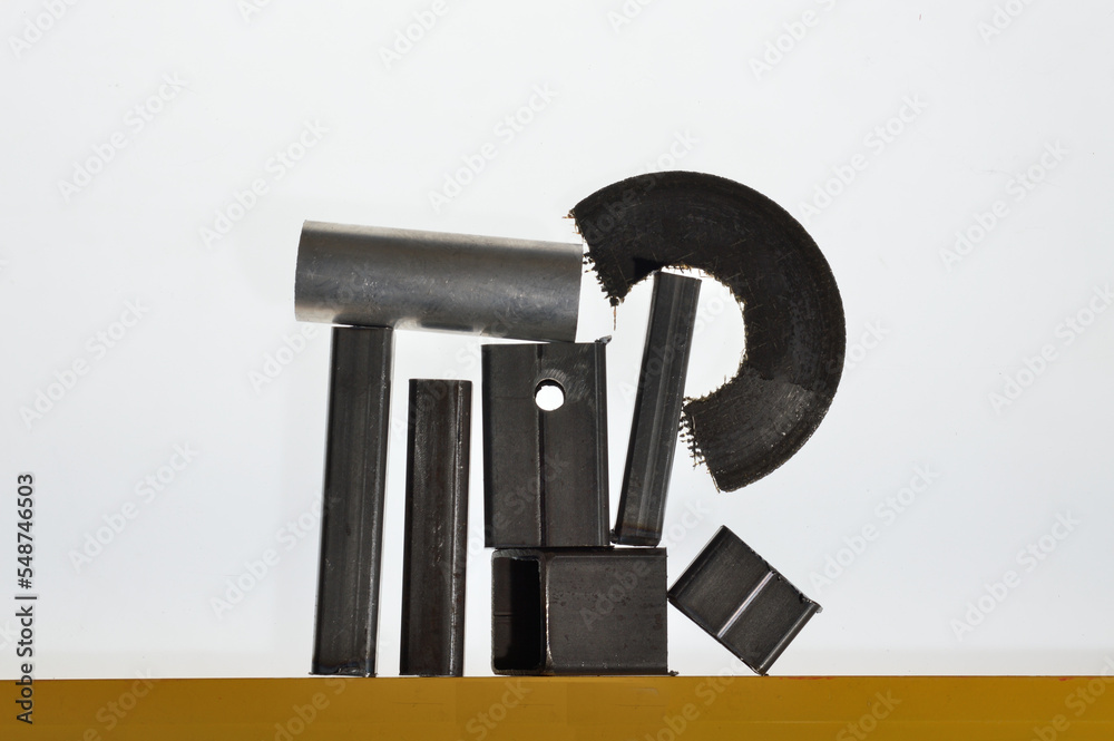 Composition of pieces of metal and a broken disk from a grinder. White ...