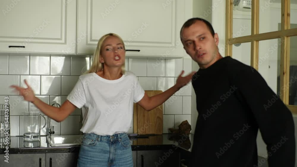 Angry emotional blonde woman scolding, raising voice, shouting and gesturing with hands at ...