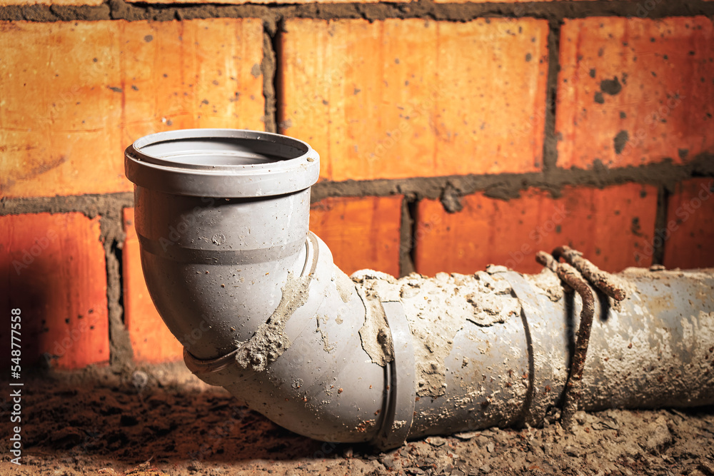 Sewer pipes in home basement. System of gray sanitary pipes when ...