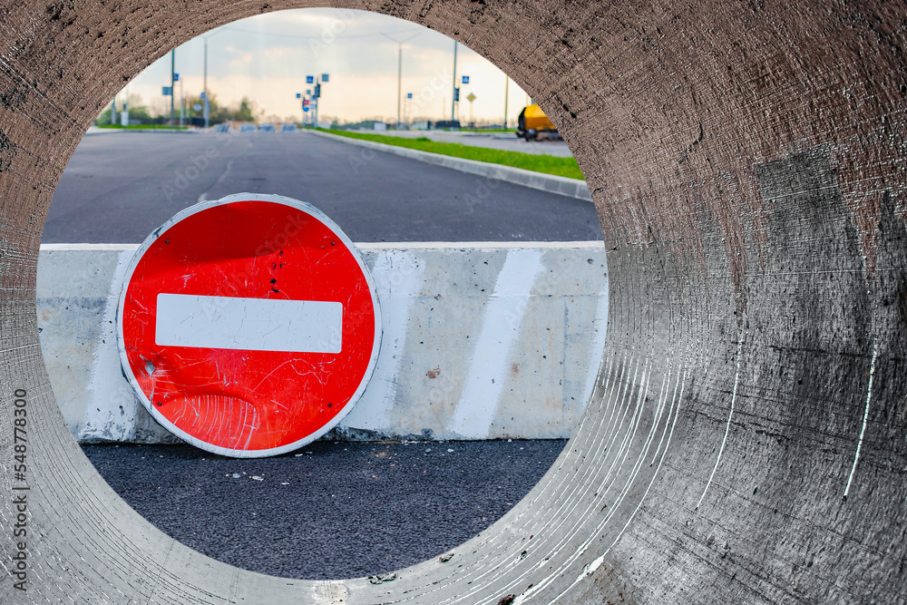 A stop road sign and concrete blocks block the entrance to the ...