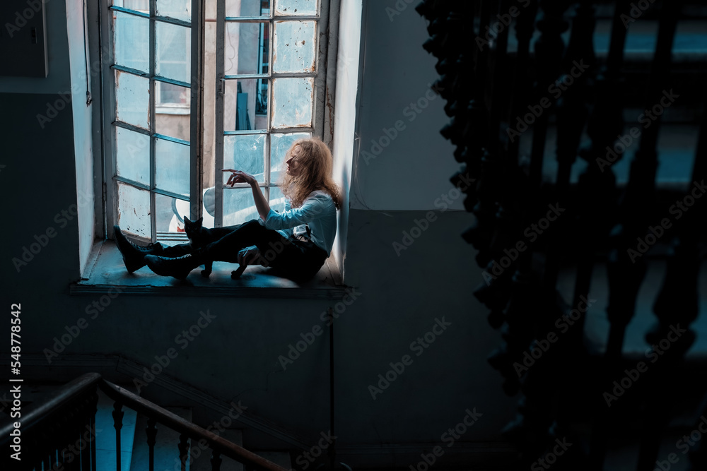 Young male model in white shirt and long white hair sitting ...