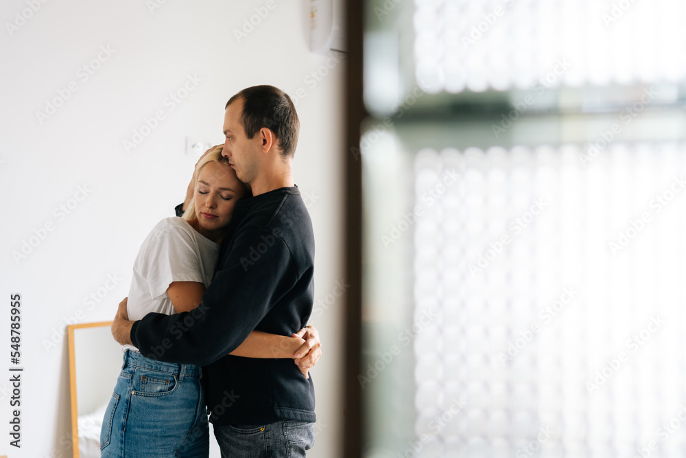 Foto de Loving man comforting supporting hugging partner wife feeling ...