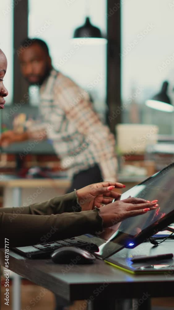 Vertical video: African american woman designing game interface on ...
