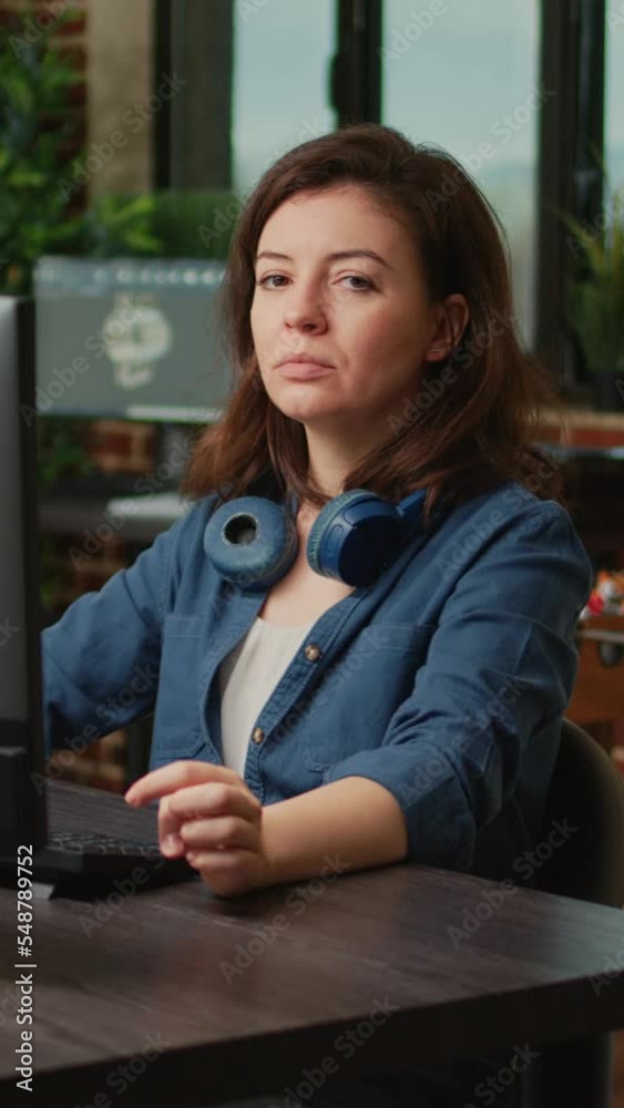 Vertical video: Woman content creator working with 3d render software ...