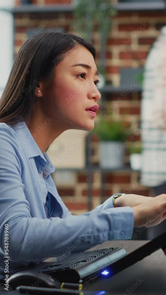Vertical video: Asian female engineer using touchscreen display to ...