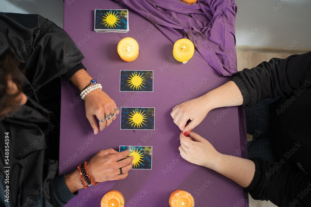 Man fortune teller holding tarot cards in his hands and unrecognizable ...