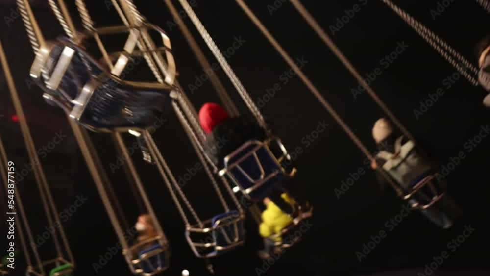 chain carousel, night illumination, amusement park, Wave Swinger ride ...