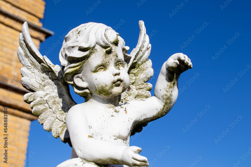 Guardian angel statue in light as a symbol of strength, truth and faith ...