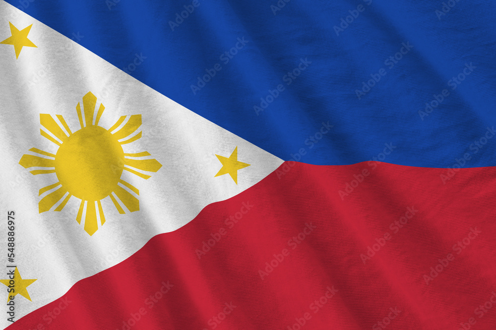 Philippines flag with big folds waving close up under the studio light ...
