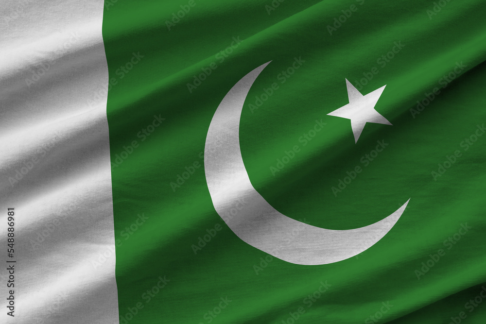 Pakistan flag with big folds waving close up under the studio light ...