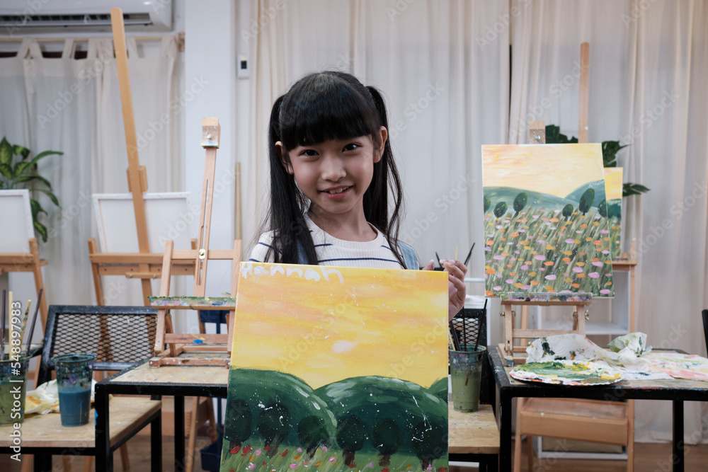 One Asian student girl shows her painting work, proud with portfolio ...