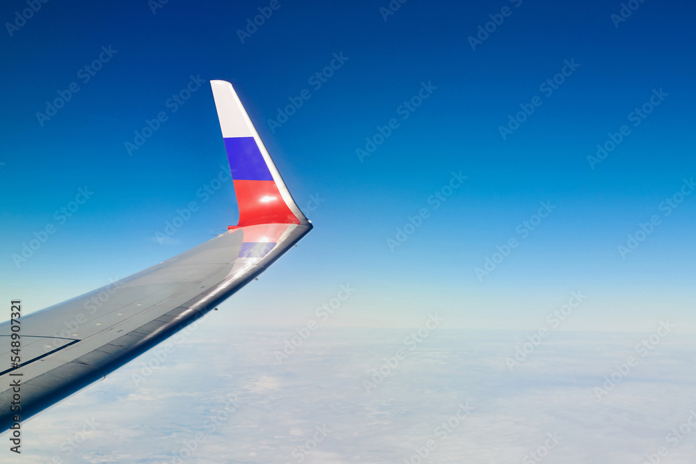 Airplane wing with Russian flag colors over clouds aerial top view from ...