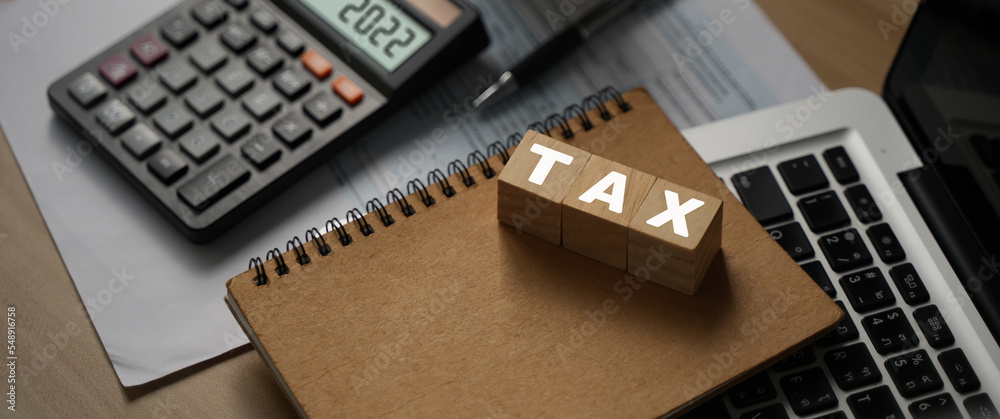 Tax word and number 2021 displayed on a wooden block. Business and tax ...
