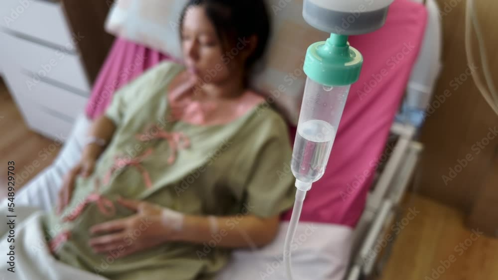 drop of saline drip in hospital with pregnant woman has a stomach ache ...