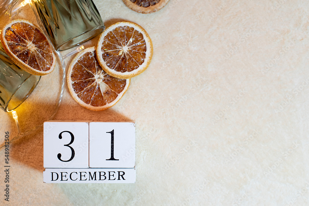 calendar with the date December 31 on a background of oranges, glasses ...