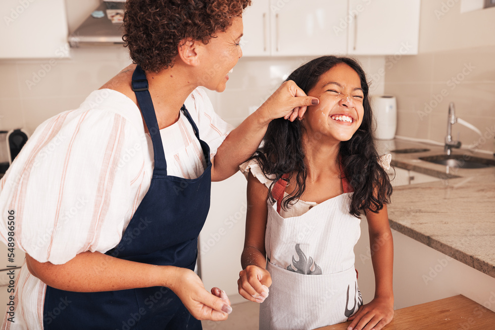 Grandmother and granddaughter are playing with flour in kitchen. Granny ...