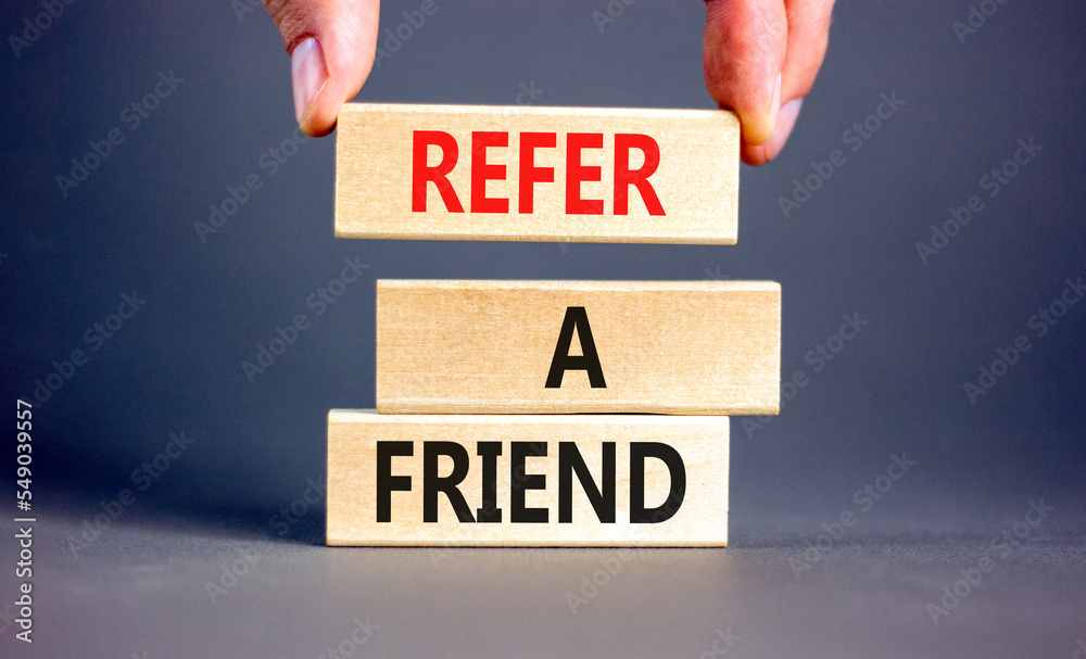 Refer a friend symbol. Concept words Refer a friend on wooden blocks on ...