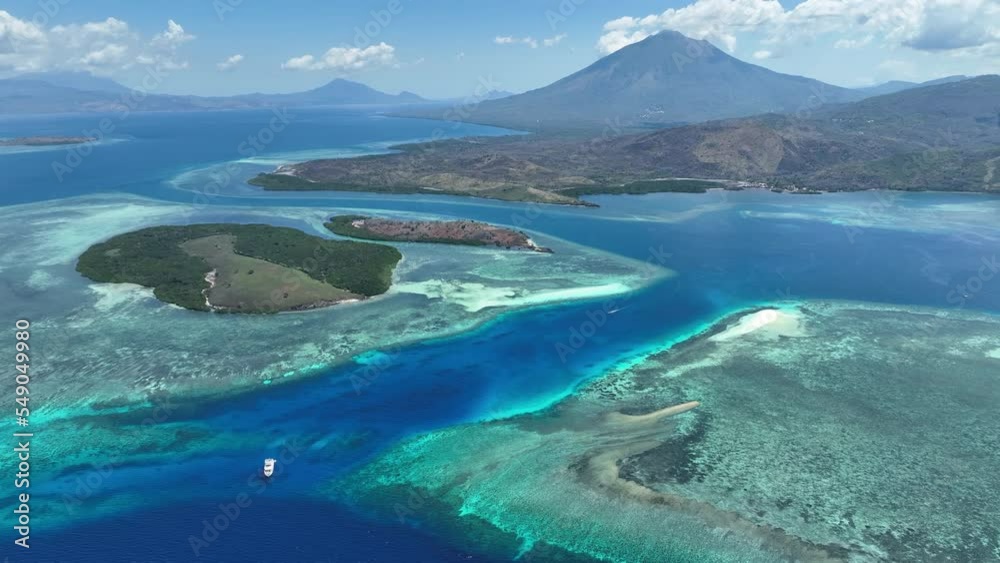 Coral reefs and seagrass meadows fringe small islands just west of ...