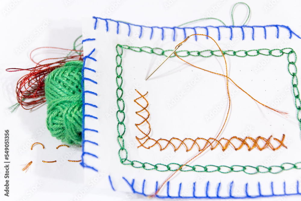 The closeup sewing process of making the colorful card during school ...