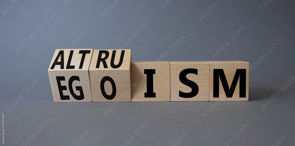 Altruism and Egoism symbol. Turned wooden cubes with words Egoism and ...