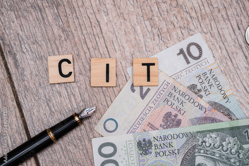 CIT inscription next to Polish money. CIT is a Corporate Income Tax ...