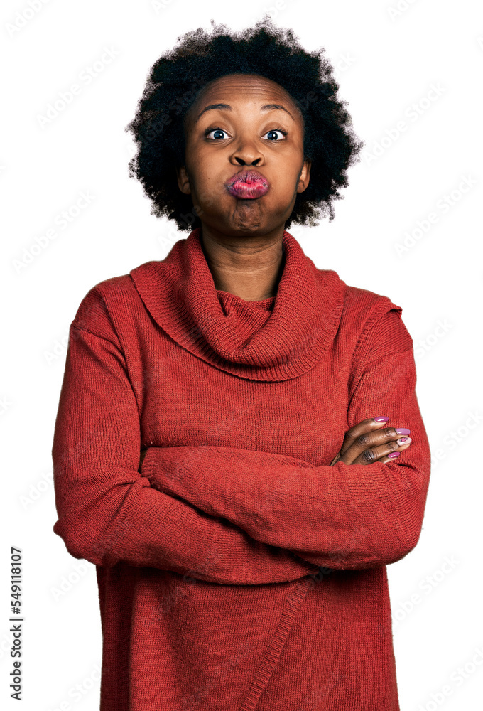 African american woman with afro hair with arms crossed gesture puffing ...