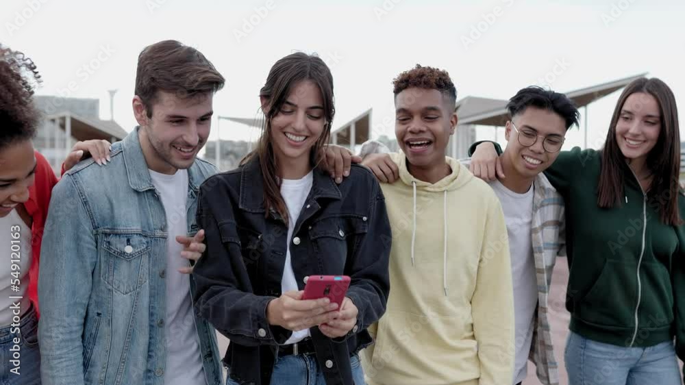 Young multiracial friends having fun looking at mobile phone screen ...