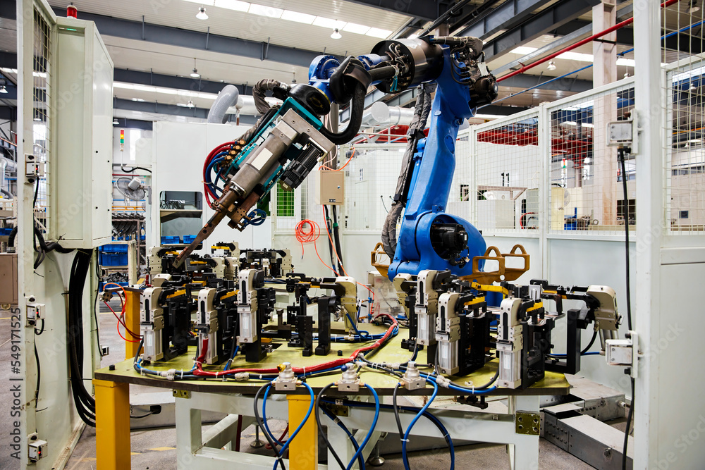 Automatic installation of blue robotic arm is working Stock Photo ...