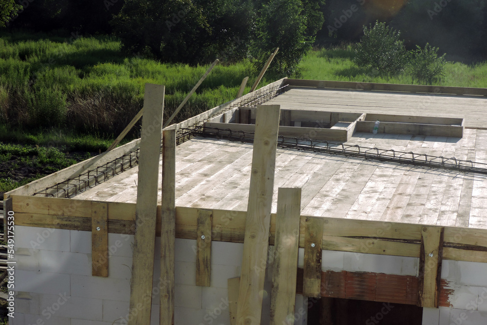 A wooden formwork for a ceiling of a first floor, a steel reinforcement ...