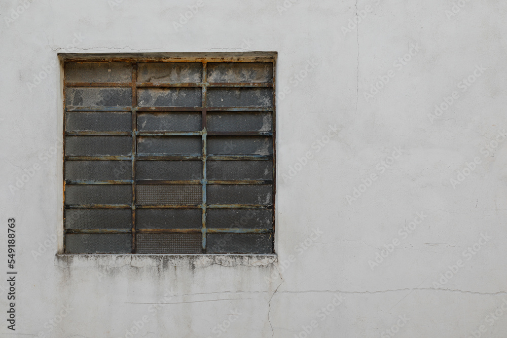 White painted house wall with glass brick stones as a window, frame ...