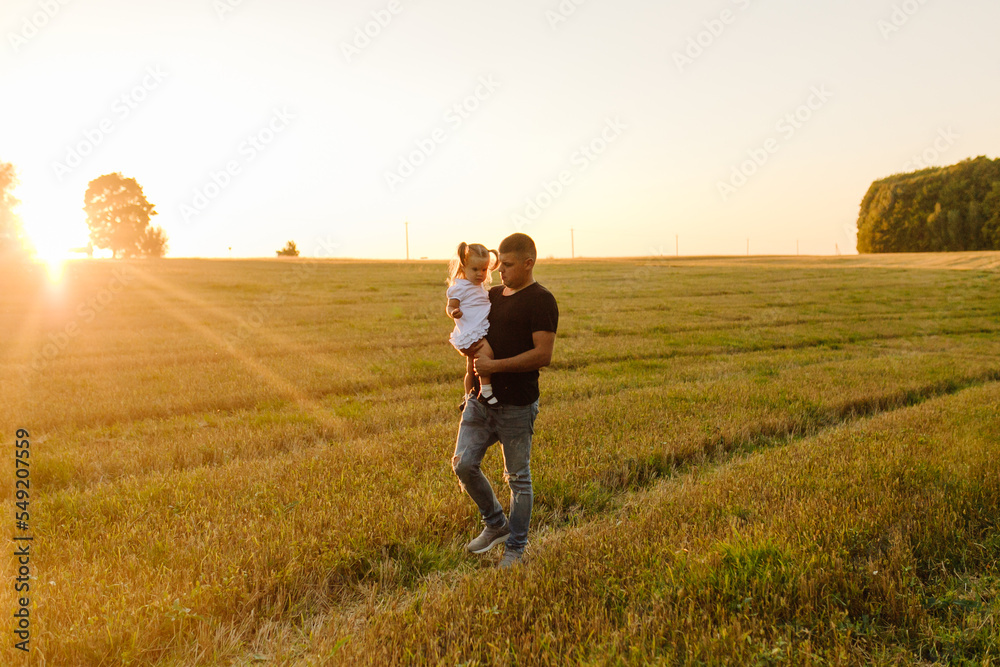 Happy family in a field in autumn. Mother, father and baby play in ...