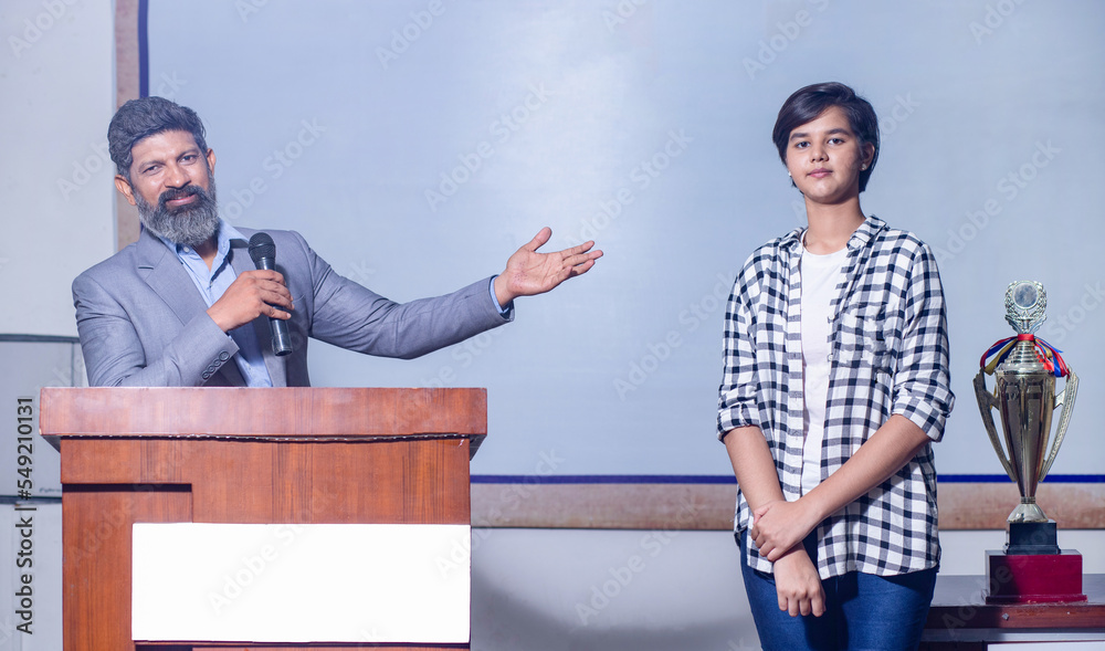 Young indian student girl appreciated and honored from the podium by ...