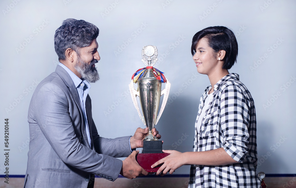 Indian man school teacher give victory trophy cup to girl student ...