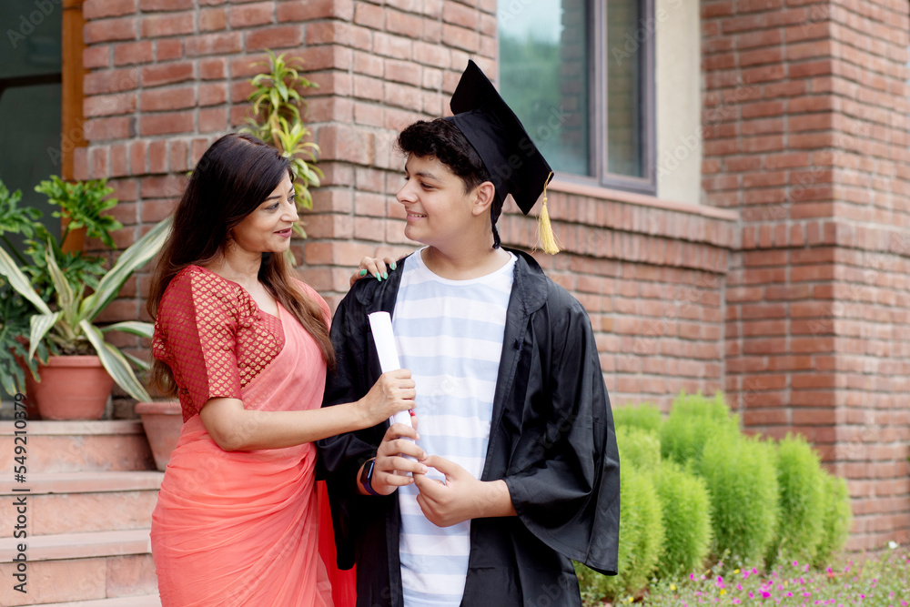 Indian university male student and proud mother celebrating graduation ...