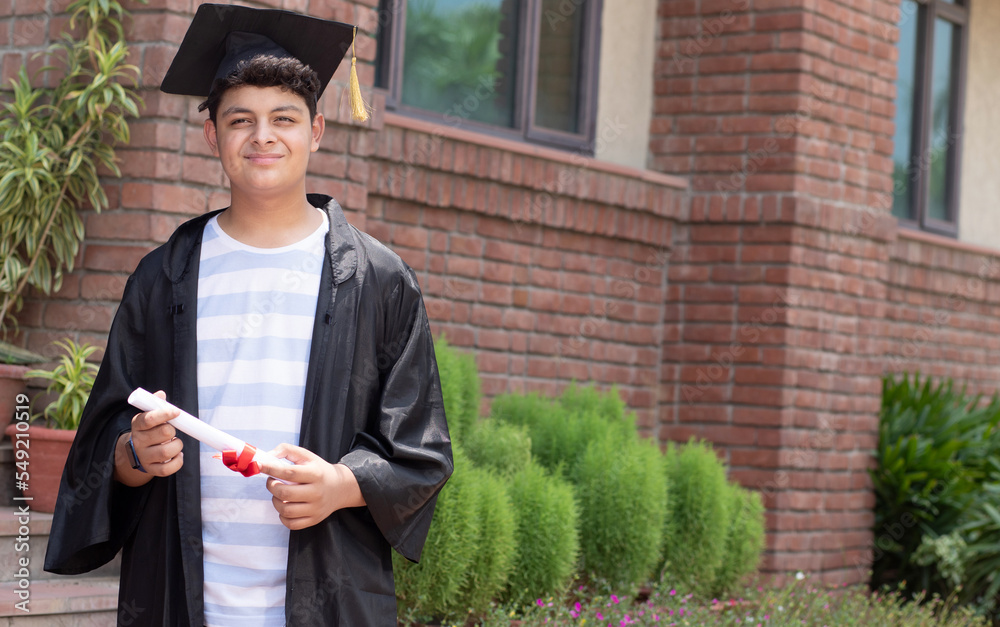 Young indian graduated boy holding his graduation degree convocation ...
