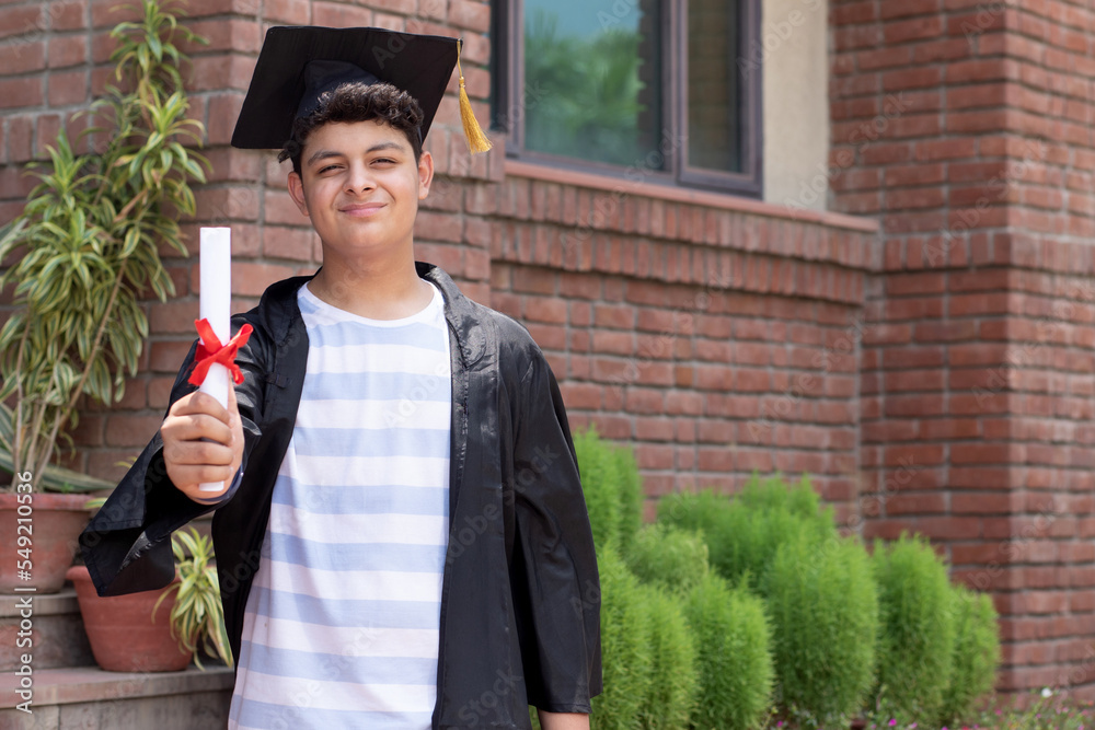 Young indian graduated boy holding his graduation degree convocation ...