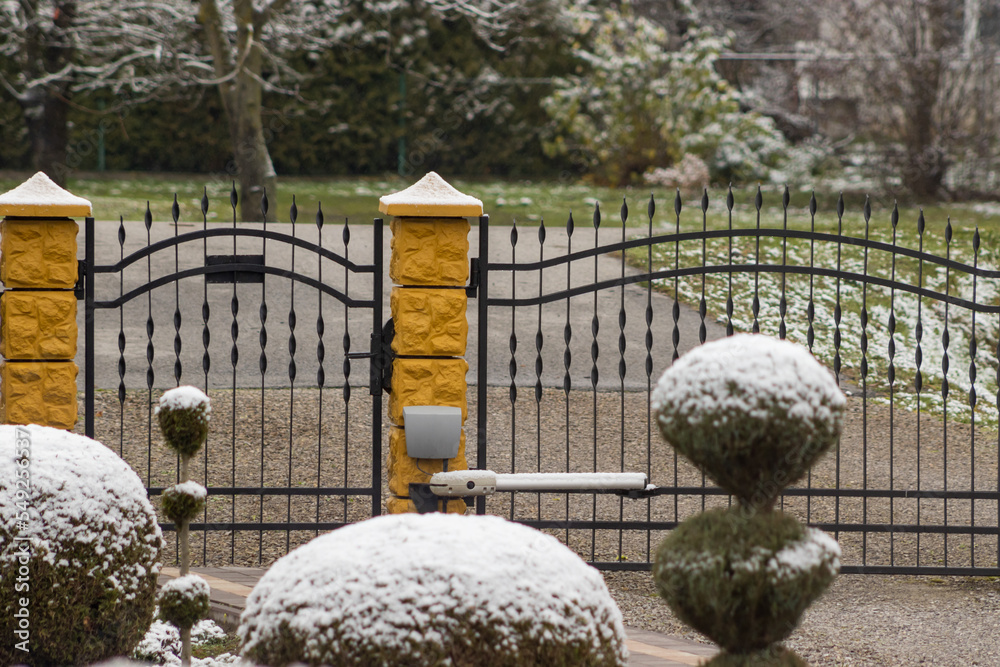 automatic door gate with motor. mechanism to open the gate. two-winged ...